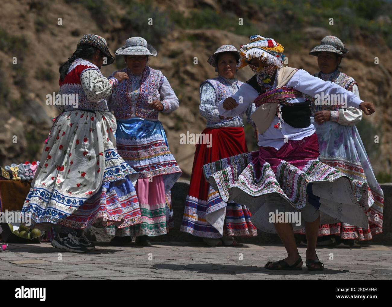 Local dancers wearing traditional local dresses and hats perform local ...