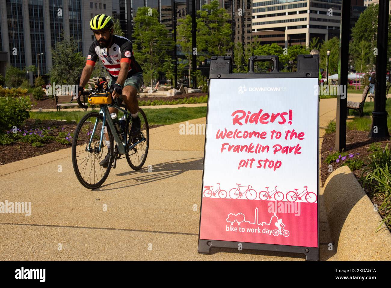 A person rides a bicycle during the 2022 Bike to Work Day in Washington ...