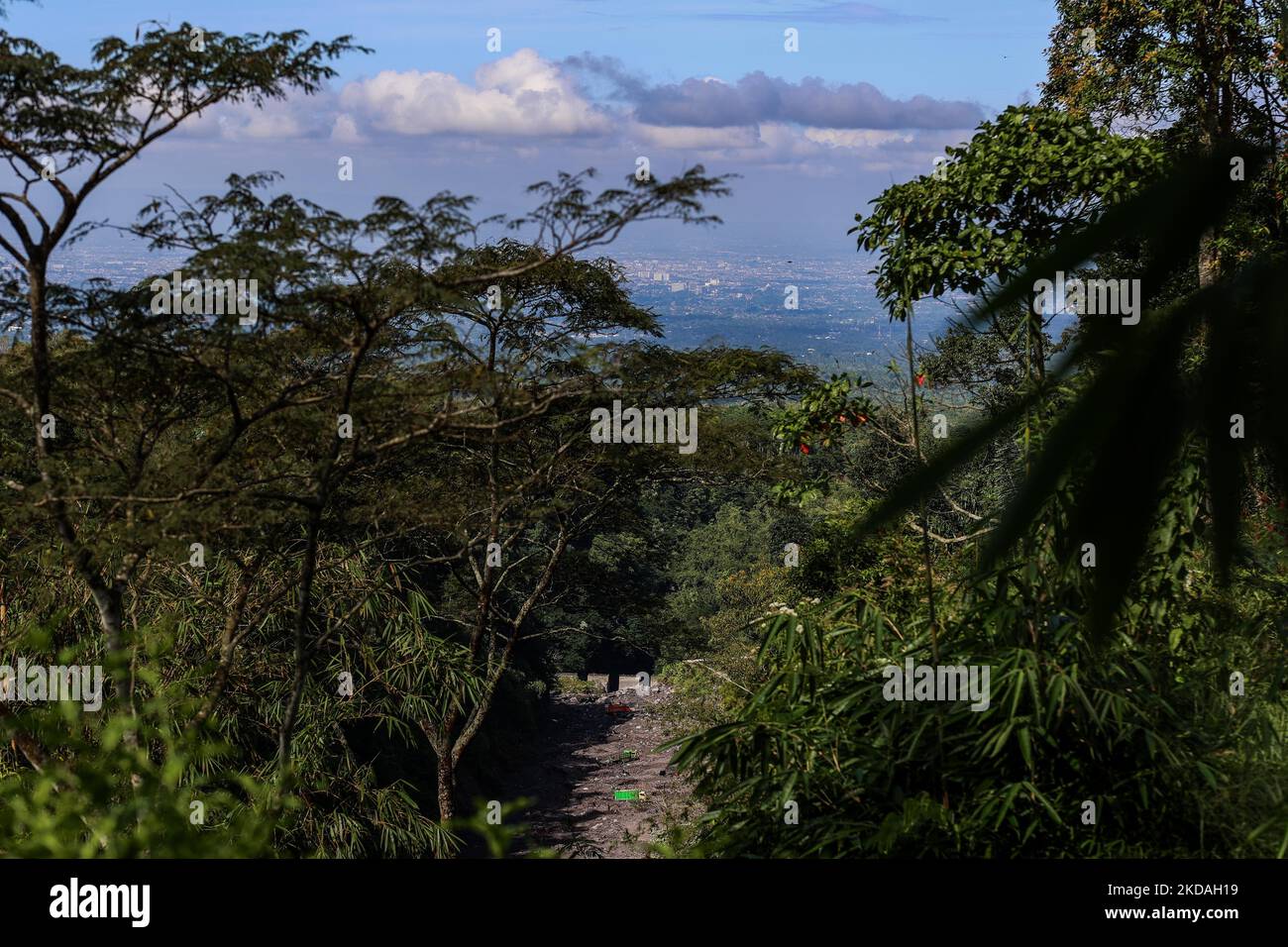 Miners dig sand from the eruption of Mount Merapi in Boyong river is ...