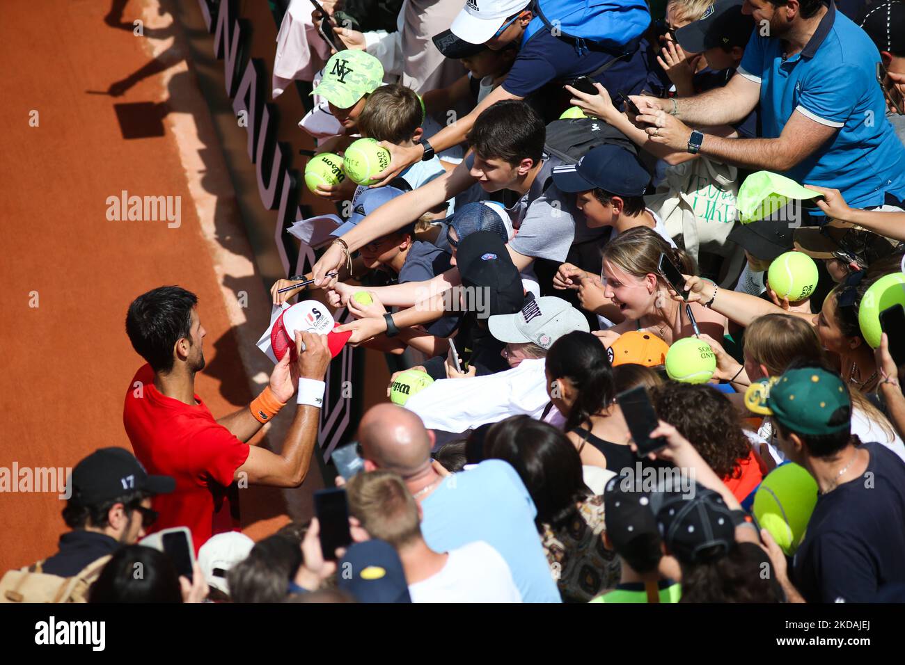 Novak Djokovic signing autographs for his fans during Roland Garros ...