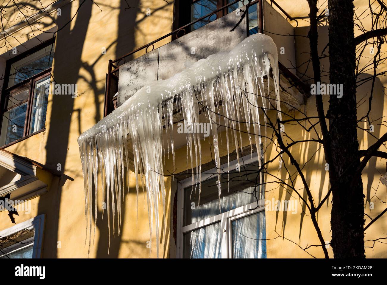 Large long icicles hanging on the balcony of an apartment building in ...