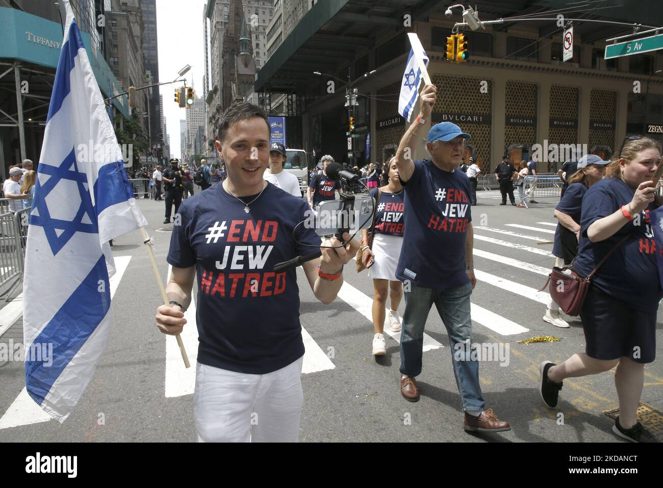 Yuval David marches along with demonstrators displaying banners and ...