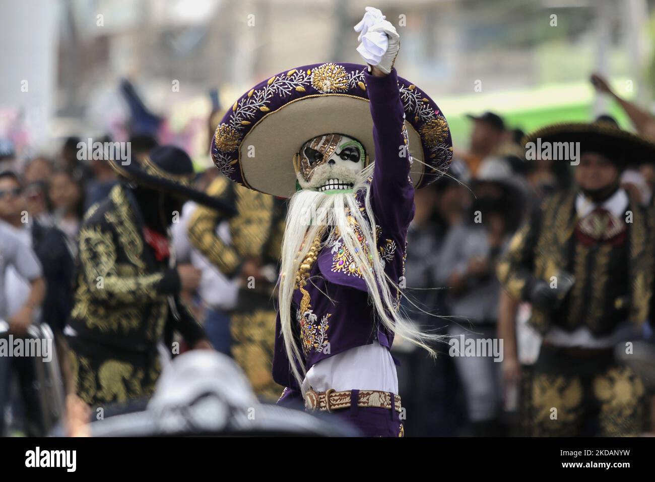 A person dressed as a charro with a skull mask during the closing of ...