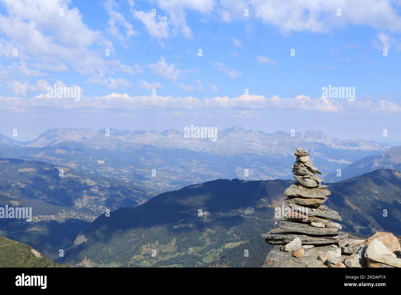 A stack of rocks overlooking the view of the Mont Blanc Mountains in ...