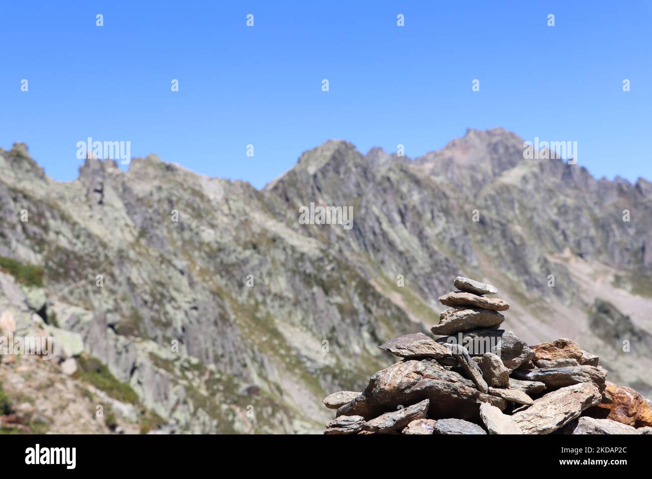 A stack of rocks overlooking the view of the Mont Blanc Mountains in ...