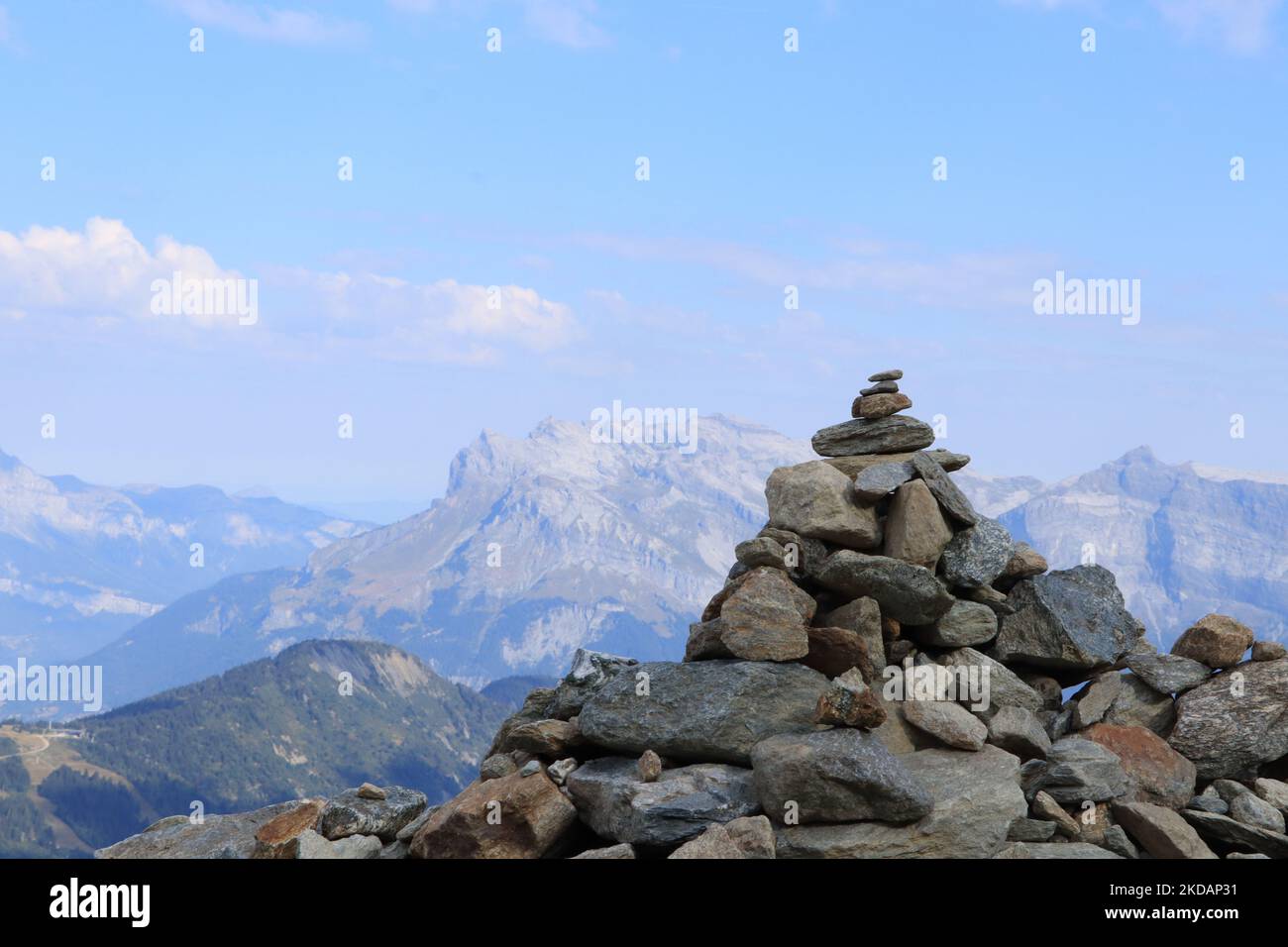 A stack of rocks overlooking the view of the Mont Blanc Mountains in ...