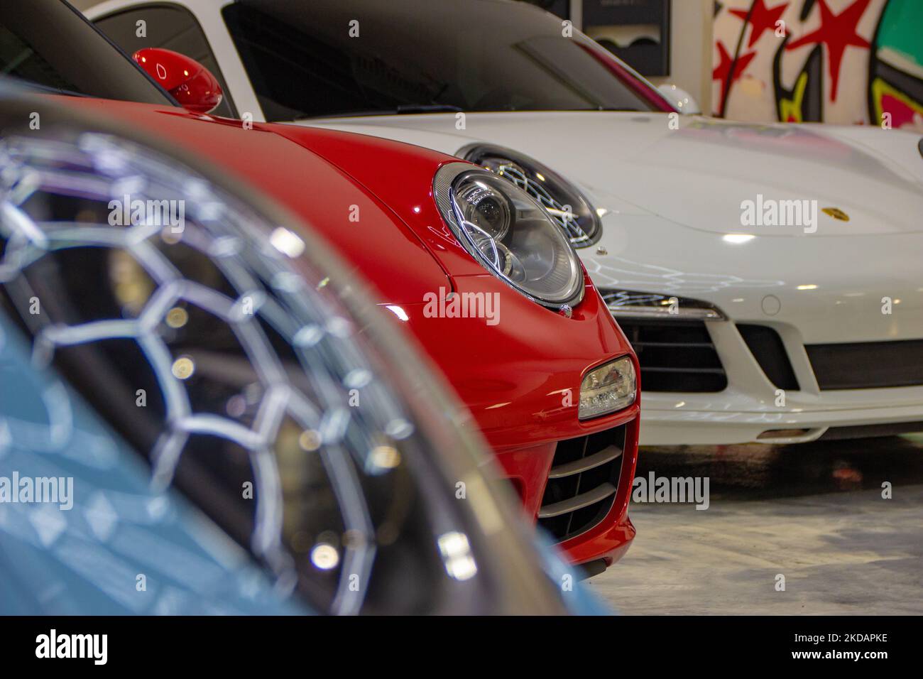 A view of the fronts of the luxury cars in the auto detailing shop and ...