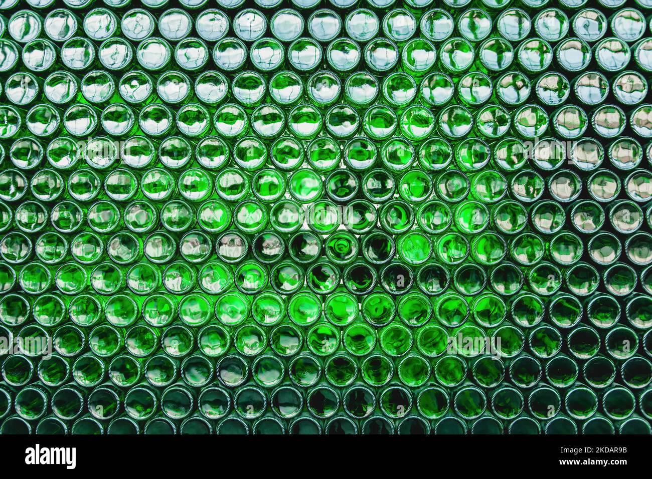 Glass bottles green. Green glass bottles of beer. Wall formed by green ...