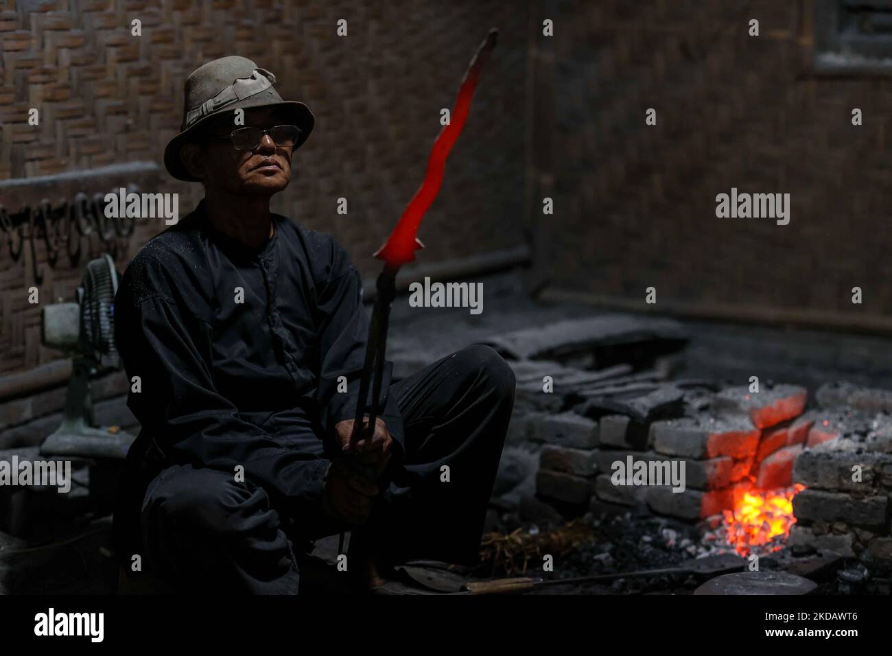 Ki Empu Sungkowo Harumbrodjo, 68, holds a Javanese Keris dagger at his ...