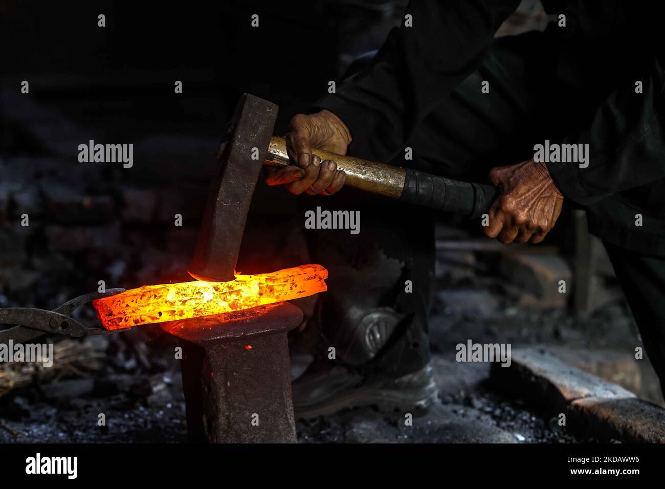 Supardi Seswowarsito, 71, hammers steel as he makes a traditional ...