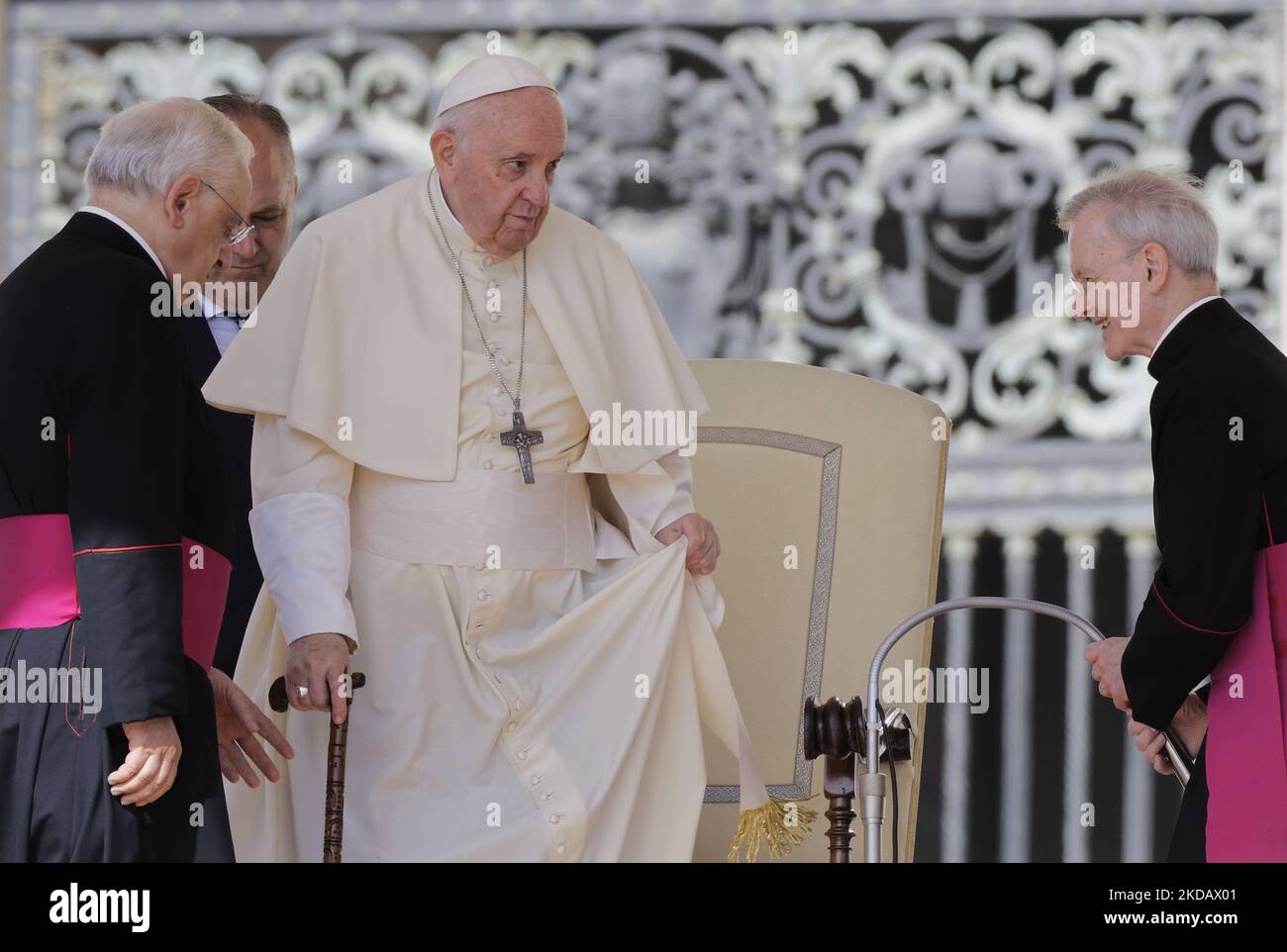 Pope Francis uses a walking stick as he arrives for his weekly general ...