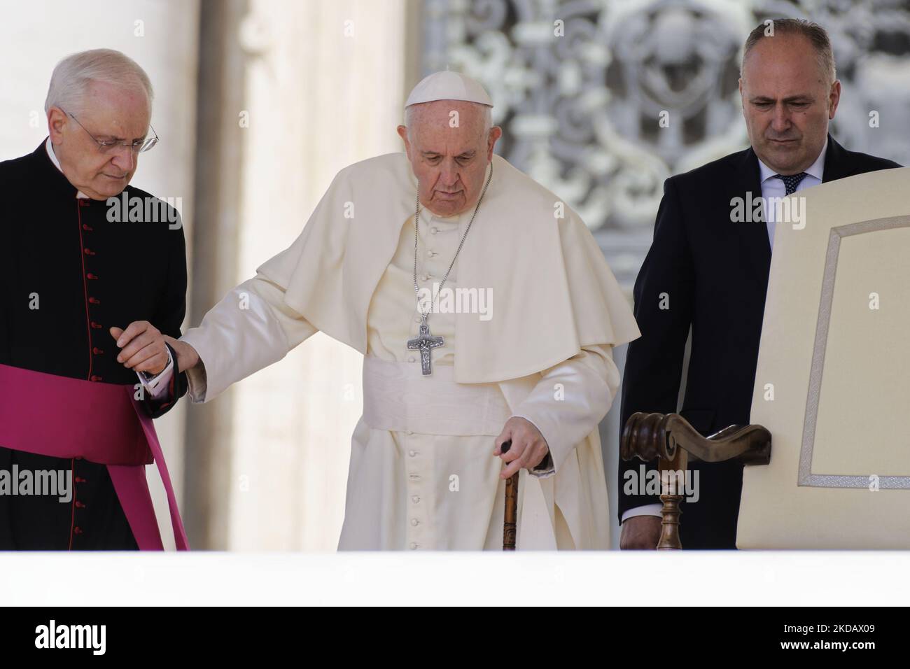 Pope Francis uses a walking stick as he arrives for his weekly general ...