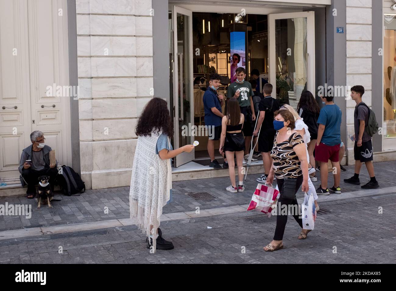 A homeless man seen outside a store in the center of Athens, Greece on ...