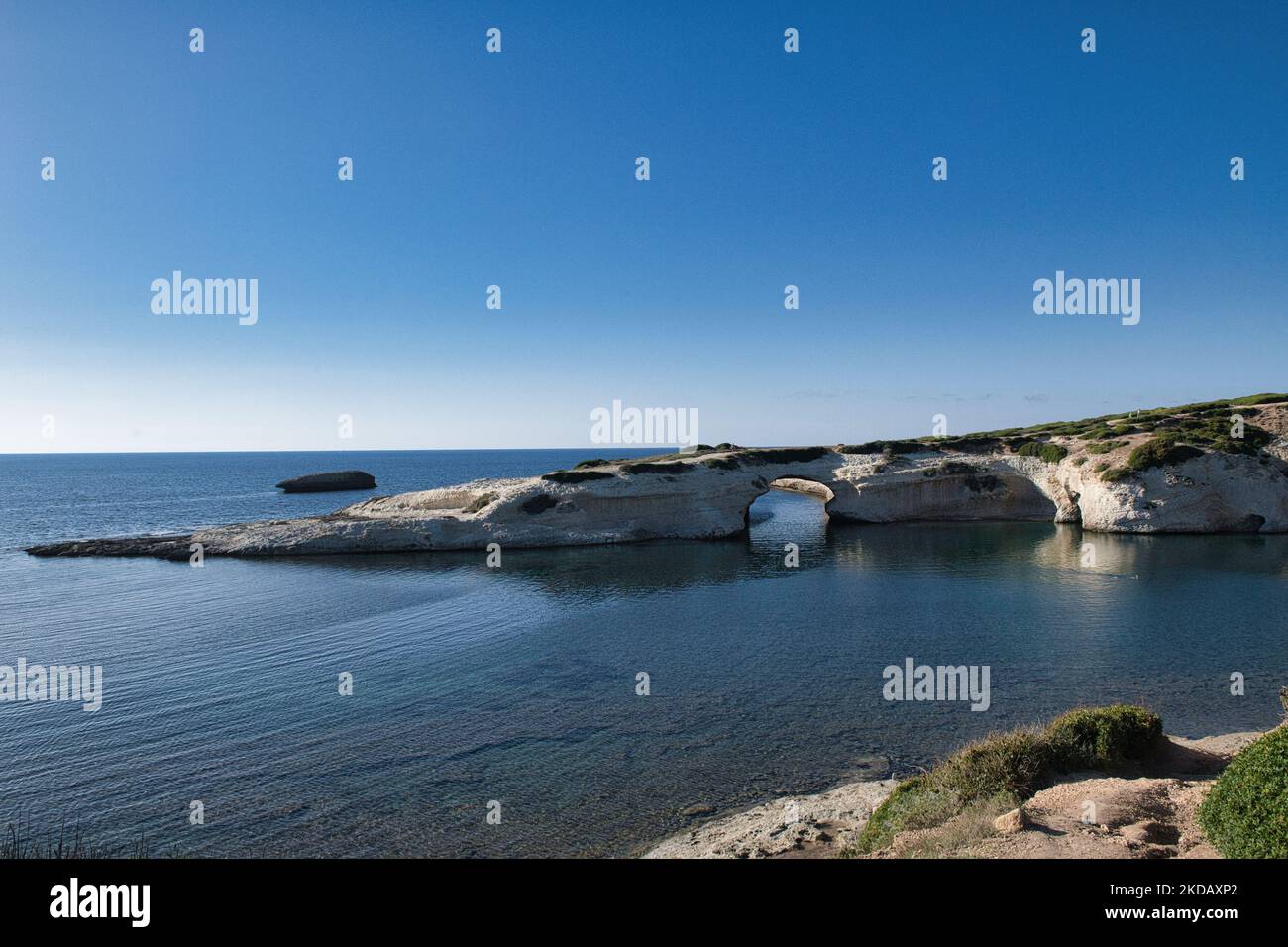 A majestic shot of Sarchittu beach and the Limestone rock with arch in ...