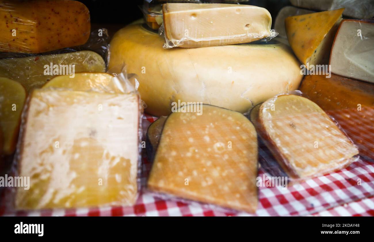 Yellow cheeses are seen on a stand in Krakow, Poland on May 25, 2022 ...