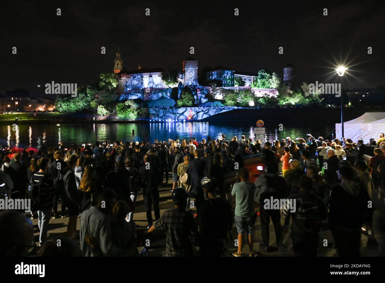 People watching the famous Wawel Castle illuminated during the Stranger ...