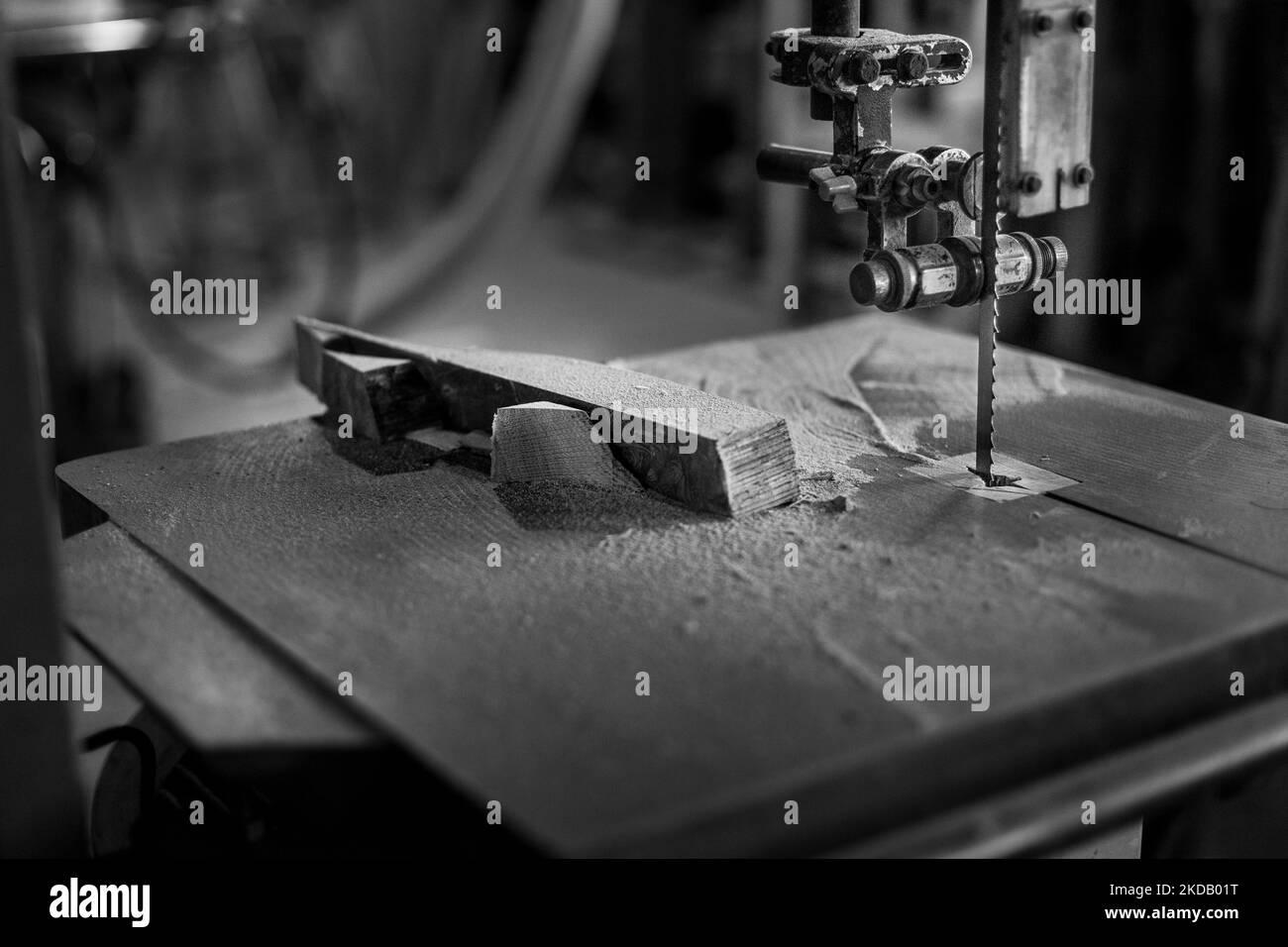 A closeup grayscale of the furniture creating process, square wood is ...