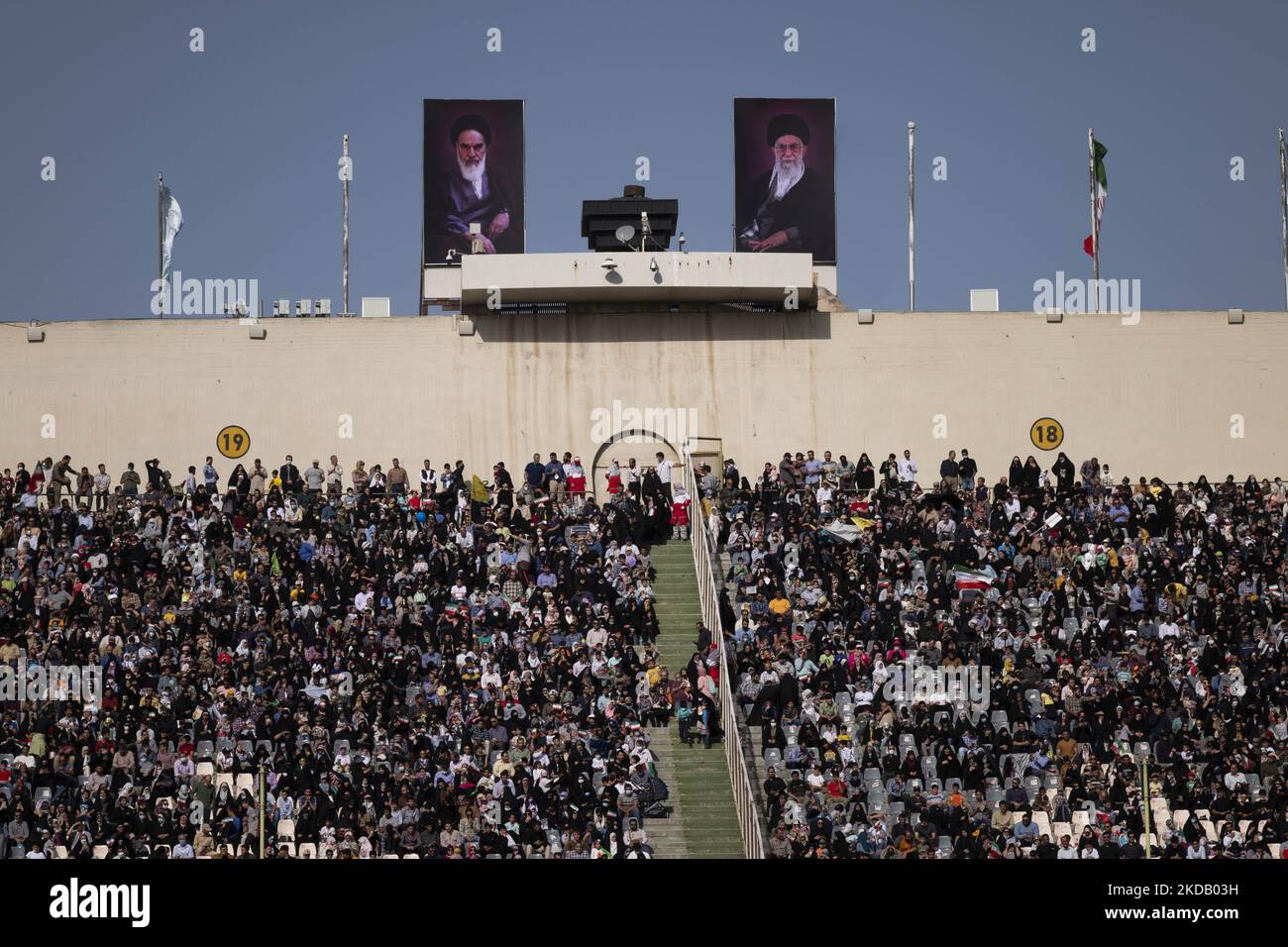 Supporters of Iran’s Supreme Leader Ayatollah Ali Khamenei sit under ...
