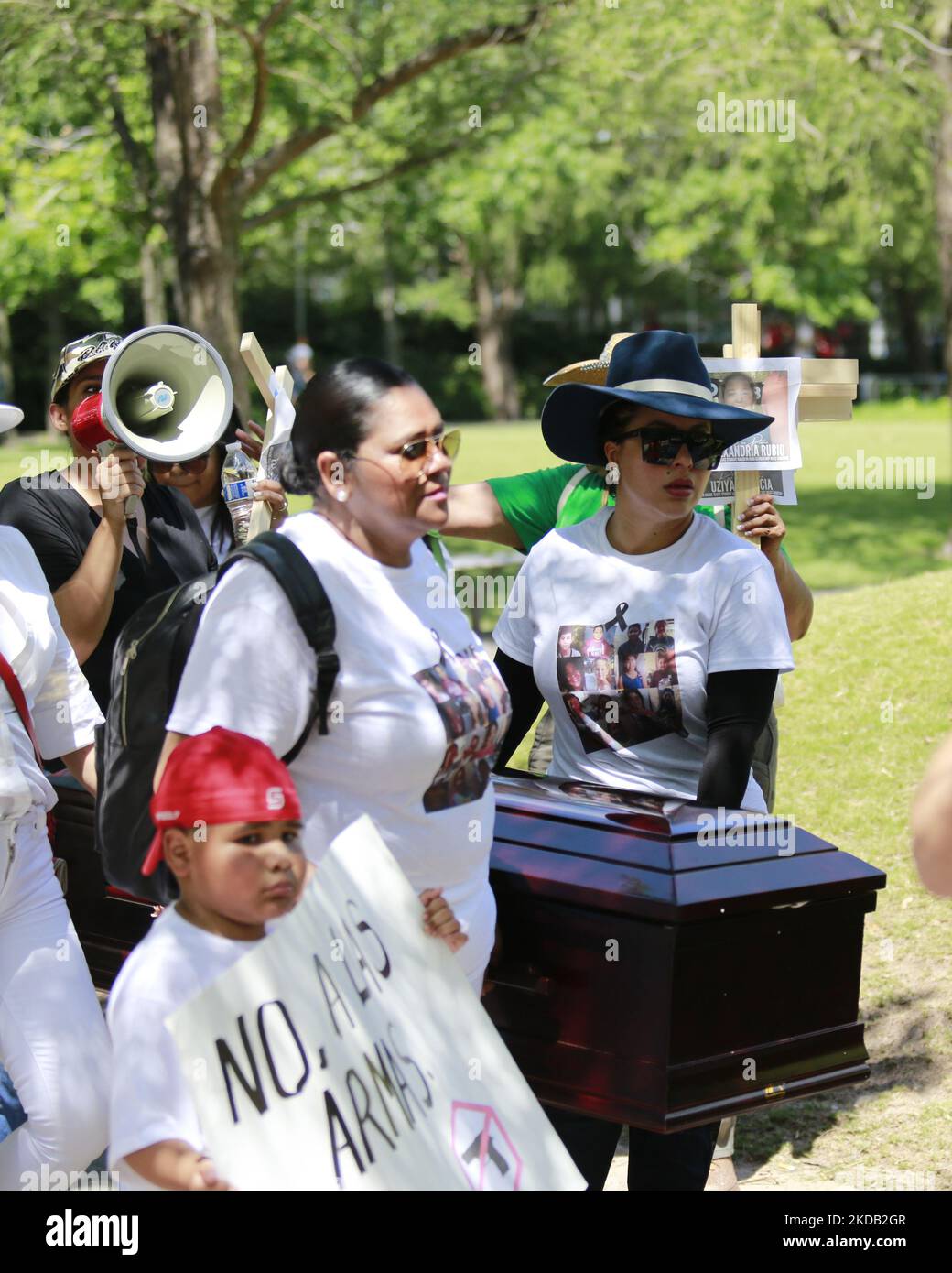 A group caries a child's coffin down the sidewalk by the George R ...