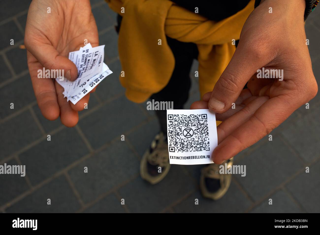An activist shows QR code denouncing the fast fashion industry they put ...