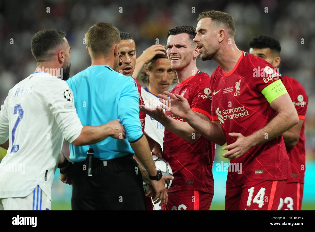 Referee Clement Turpin is confronted Jordan Henderson of Liverpool FC ...