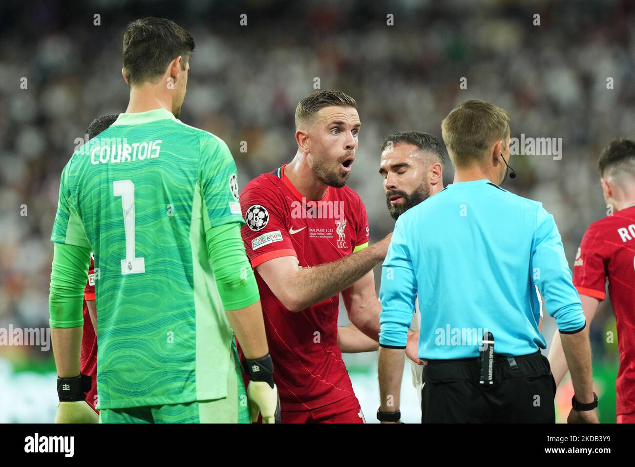 Referee Clement Turpin is confronted Jordan Henderson of Liverpool FC ...