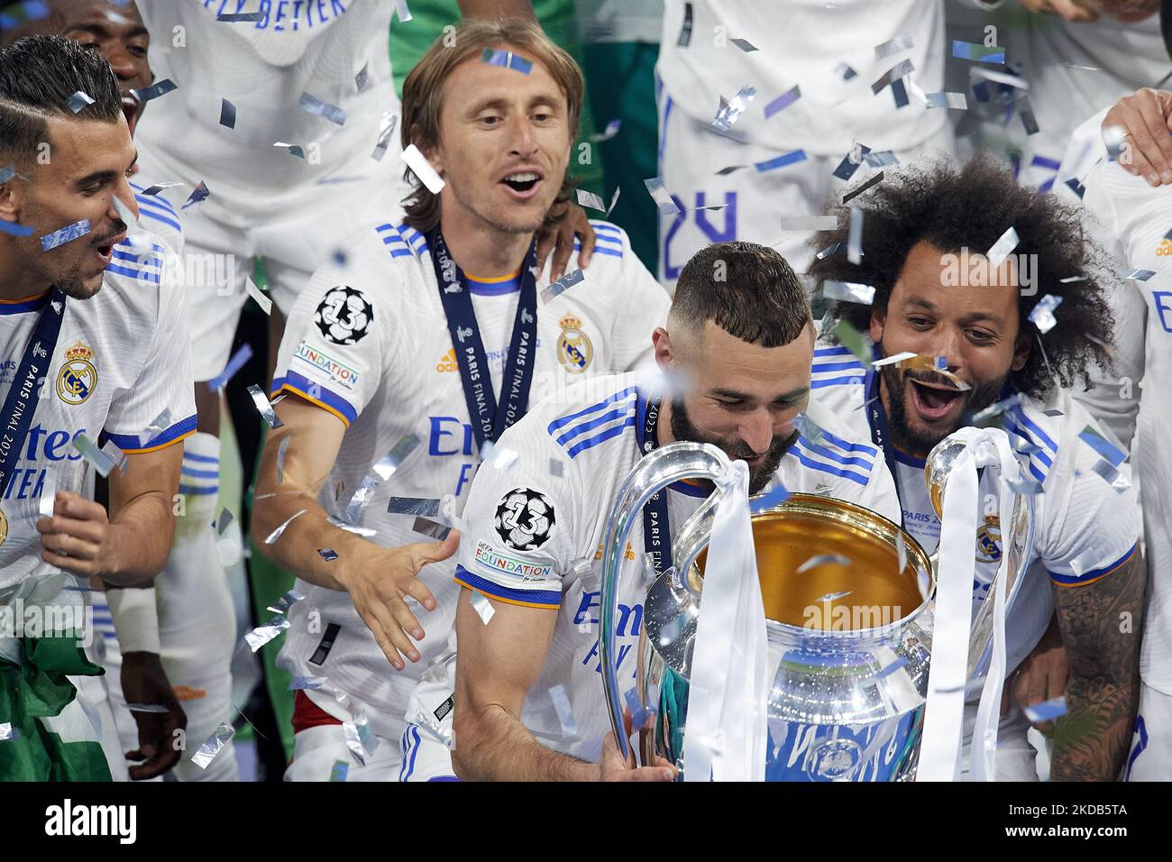 Karim Benzema of Real Madrid lifts the trophy after winning with his ...