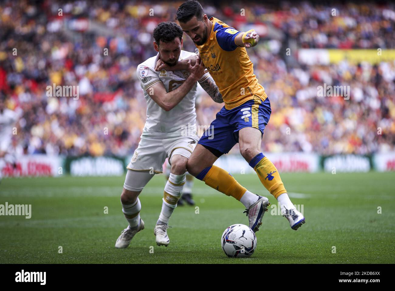 Stephen McLaughlin of Mansfield Town on the ball under pressure during ...