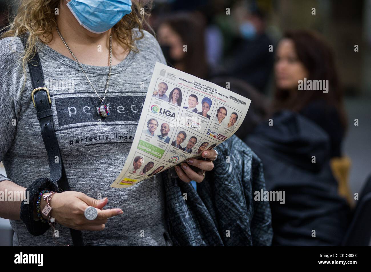 A voter walks with her ballot during the 2022 Presidential elections in ...