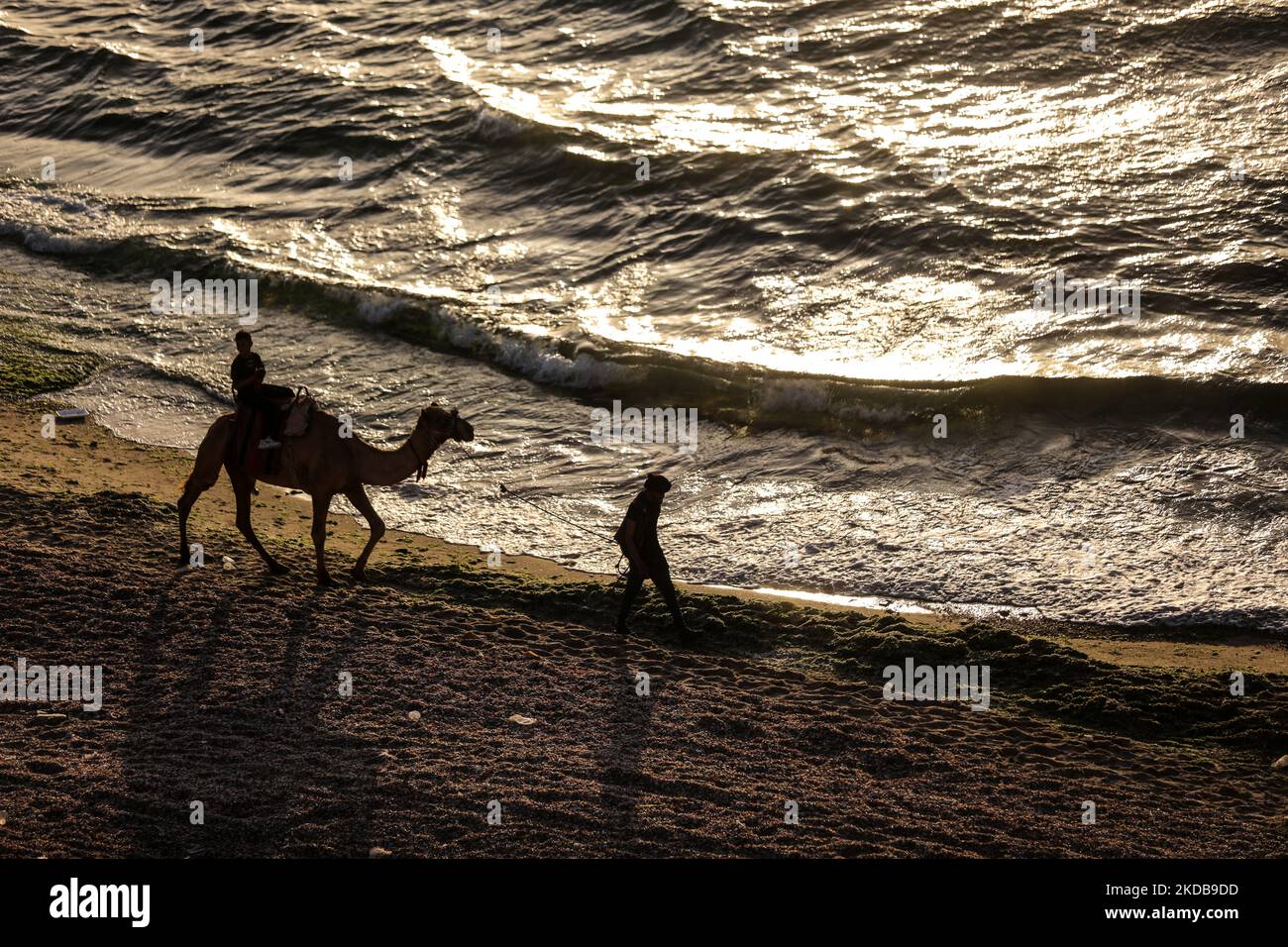 Palestinians enjoy the beach of the sea in Deir al-Balah in the center ...