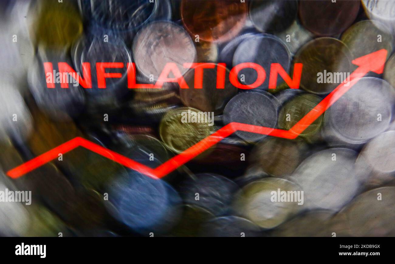 Photograph of coins and an illustrative graph with 'inflation' sign are ...