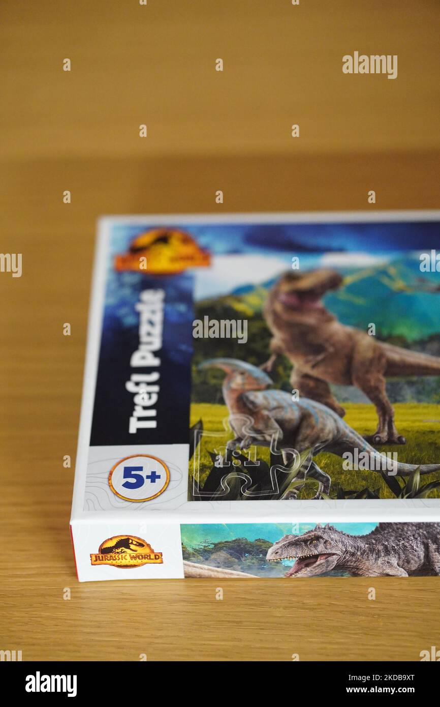 A Trefl brand Jurassic World dinosaur puzzle in a box laying on a table ...