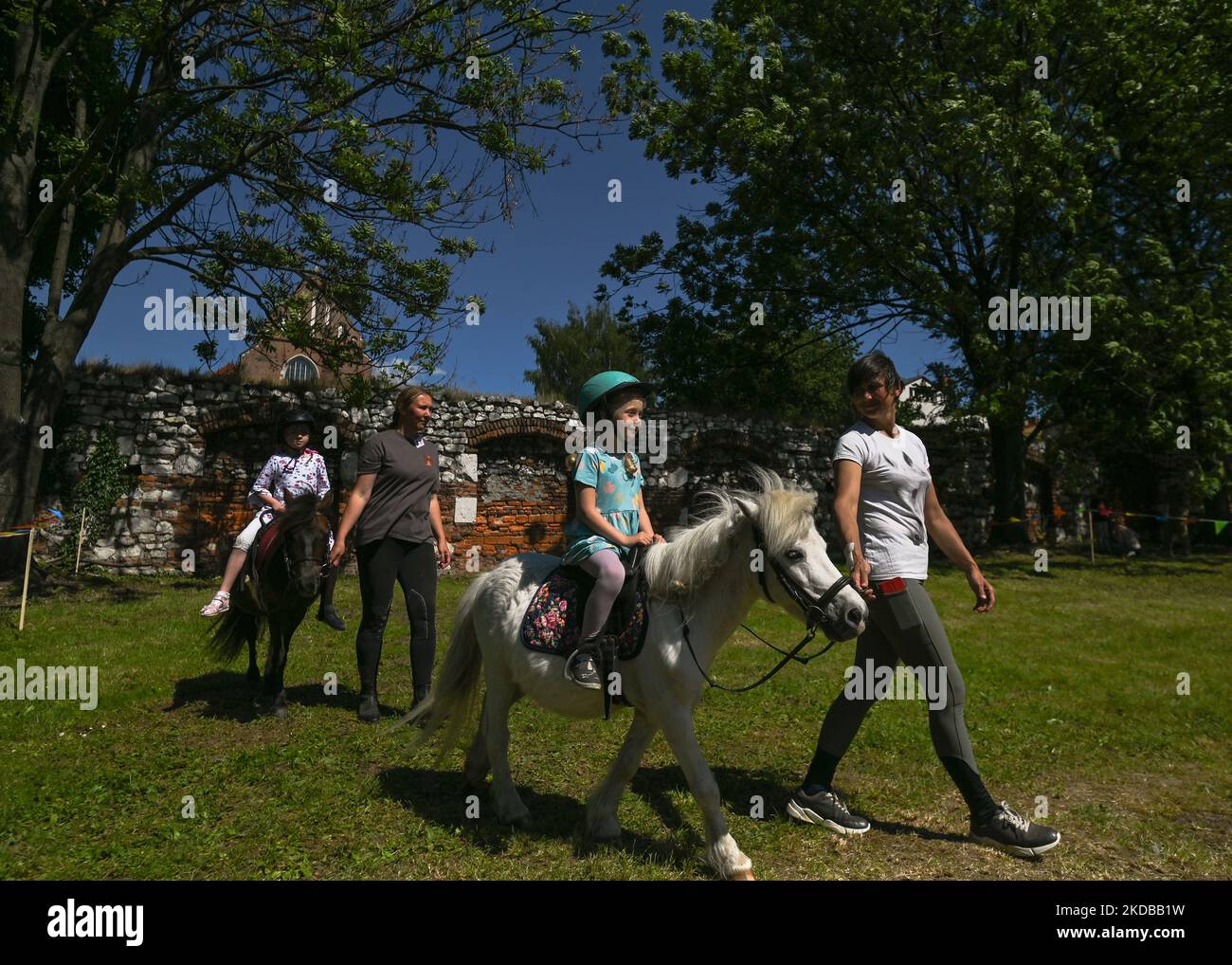 Happy little kids as they enjoying a free pony ride. The Augustinian ...