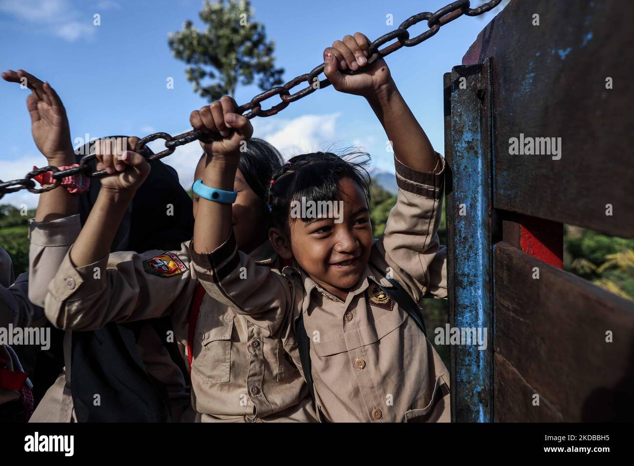 Students are huddling together in a truck to going school in Tugu Utara ...