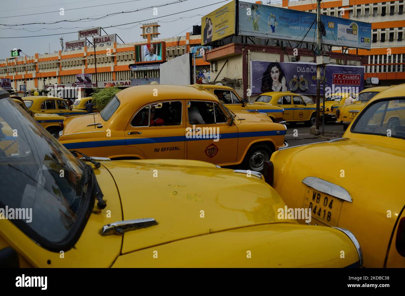 A yellow taxi parking area is seen infront of a railway station in ...