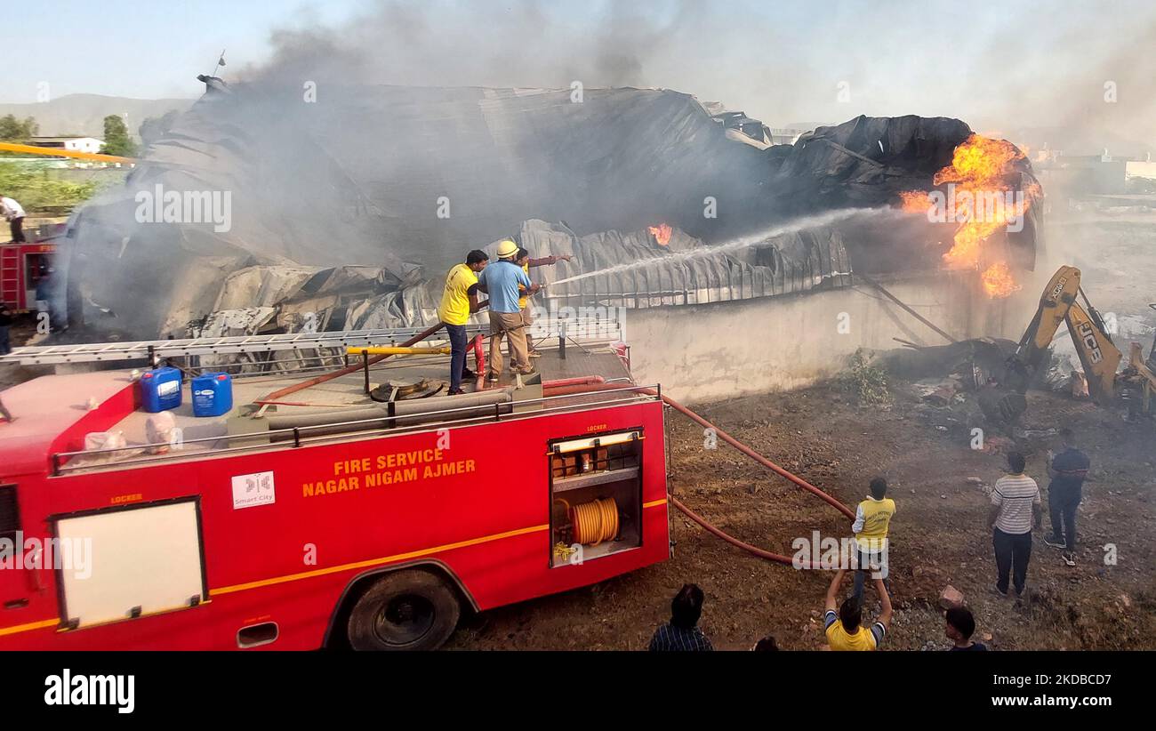Indian Fire fighters attempt to douse flames after a fire broke out in ...