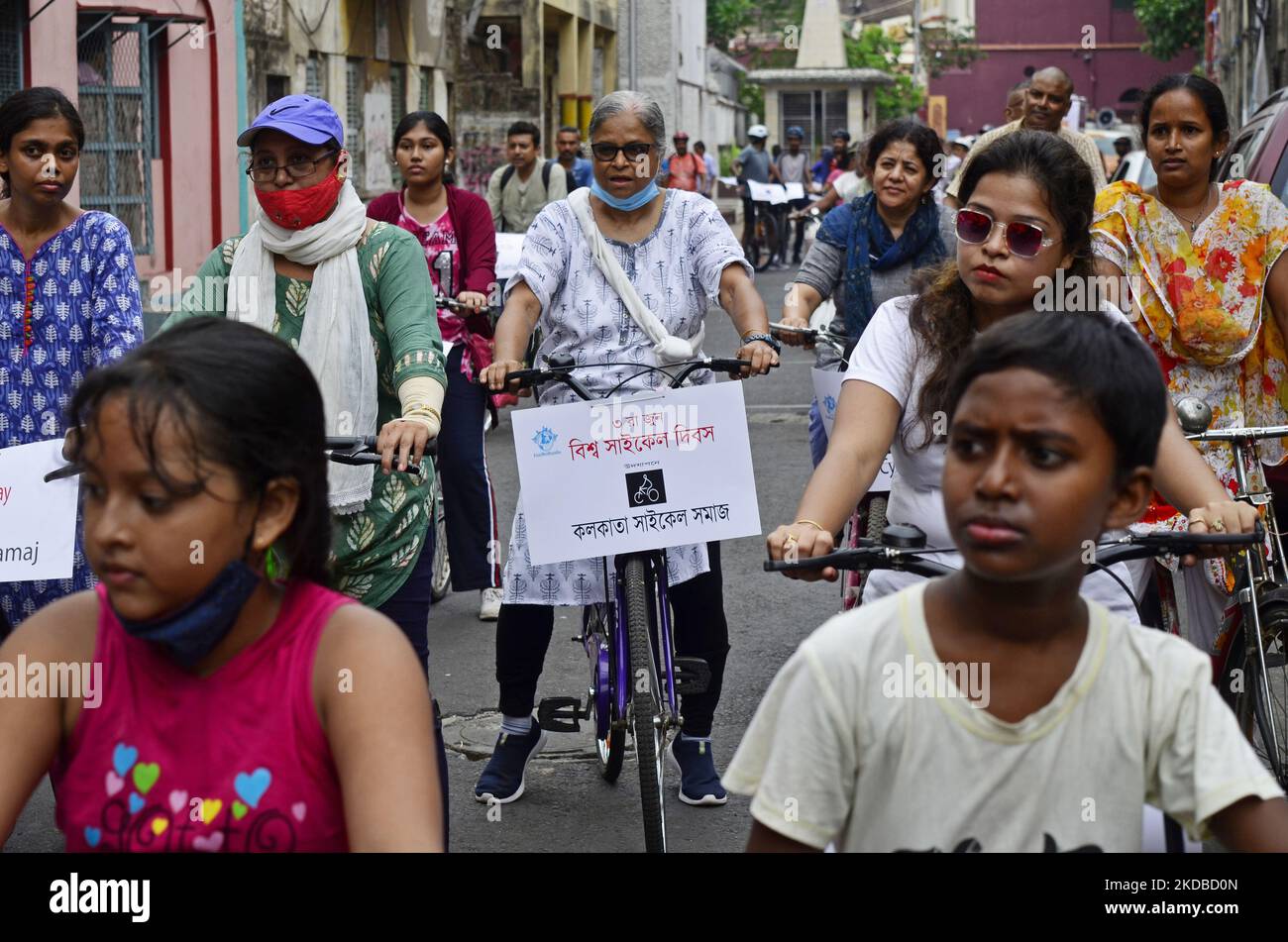 An old woman participates in a bicycle rally to observe the World ...