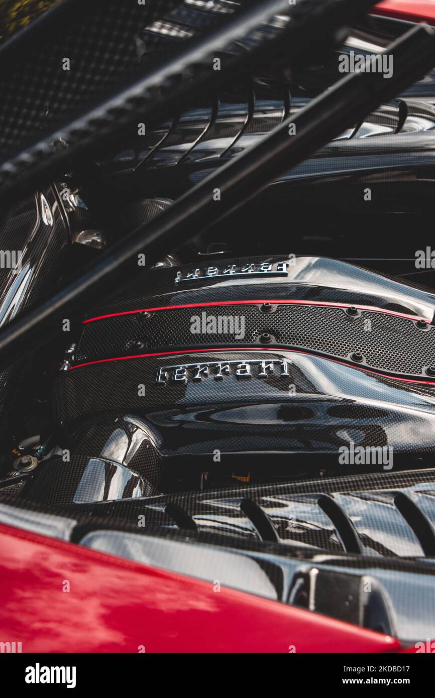 A vertical shot of a Ferrari Engine bay with red detailing and Ferrari ...