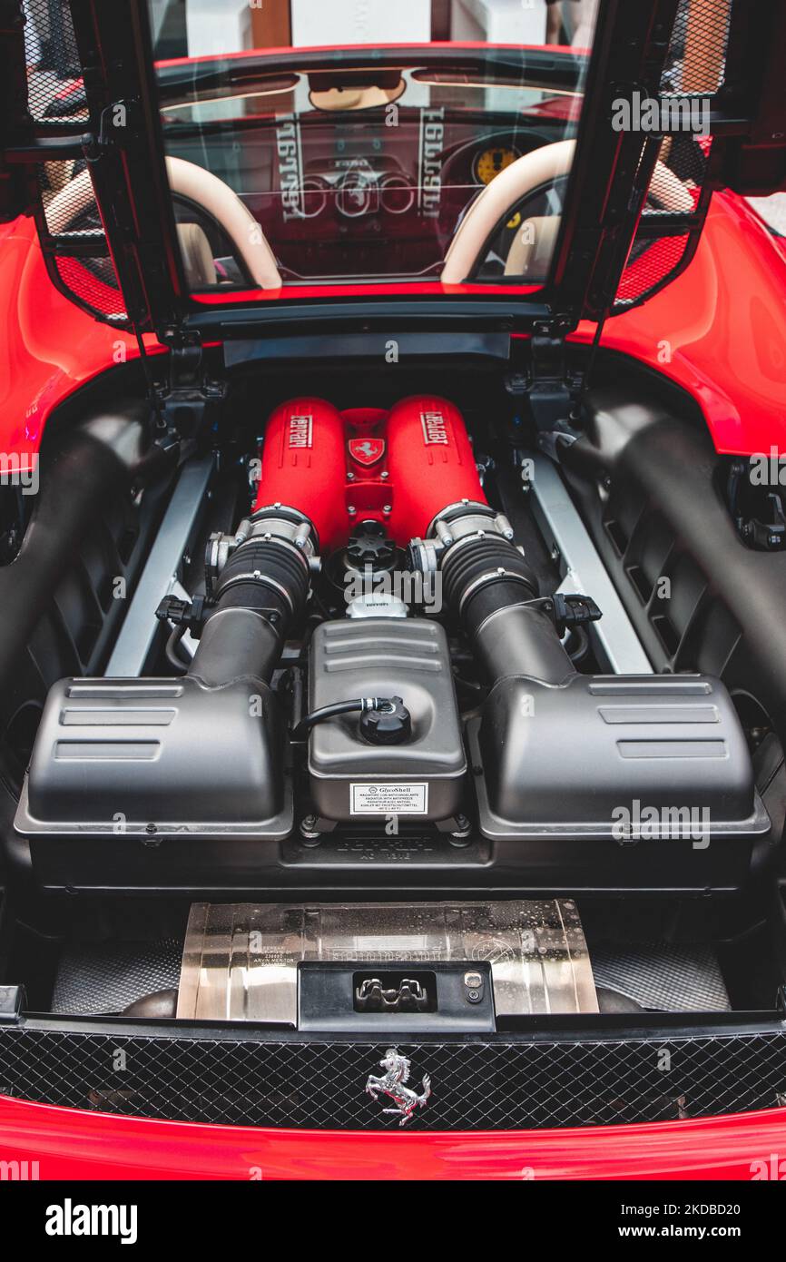 A vertical shot of a Ferrari Engine bay with red detailing and Ferrari ...