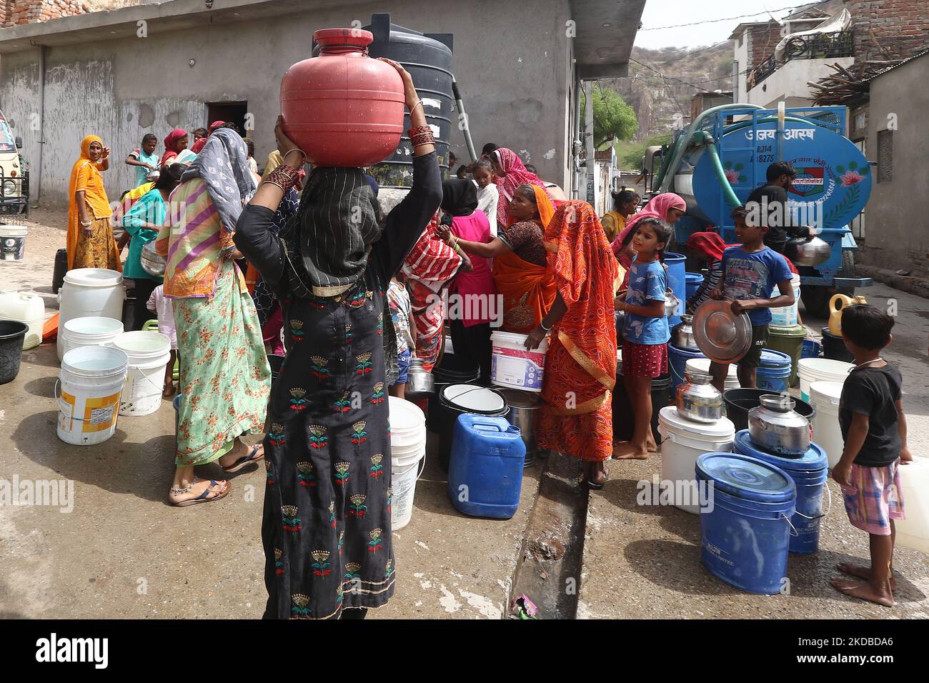 Residents collect drinking water from a Nagar Nigam tanker due to water ...