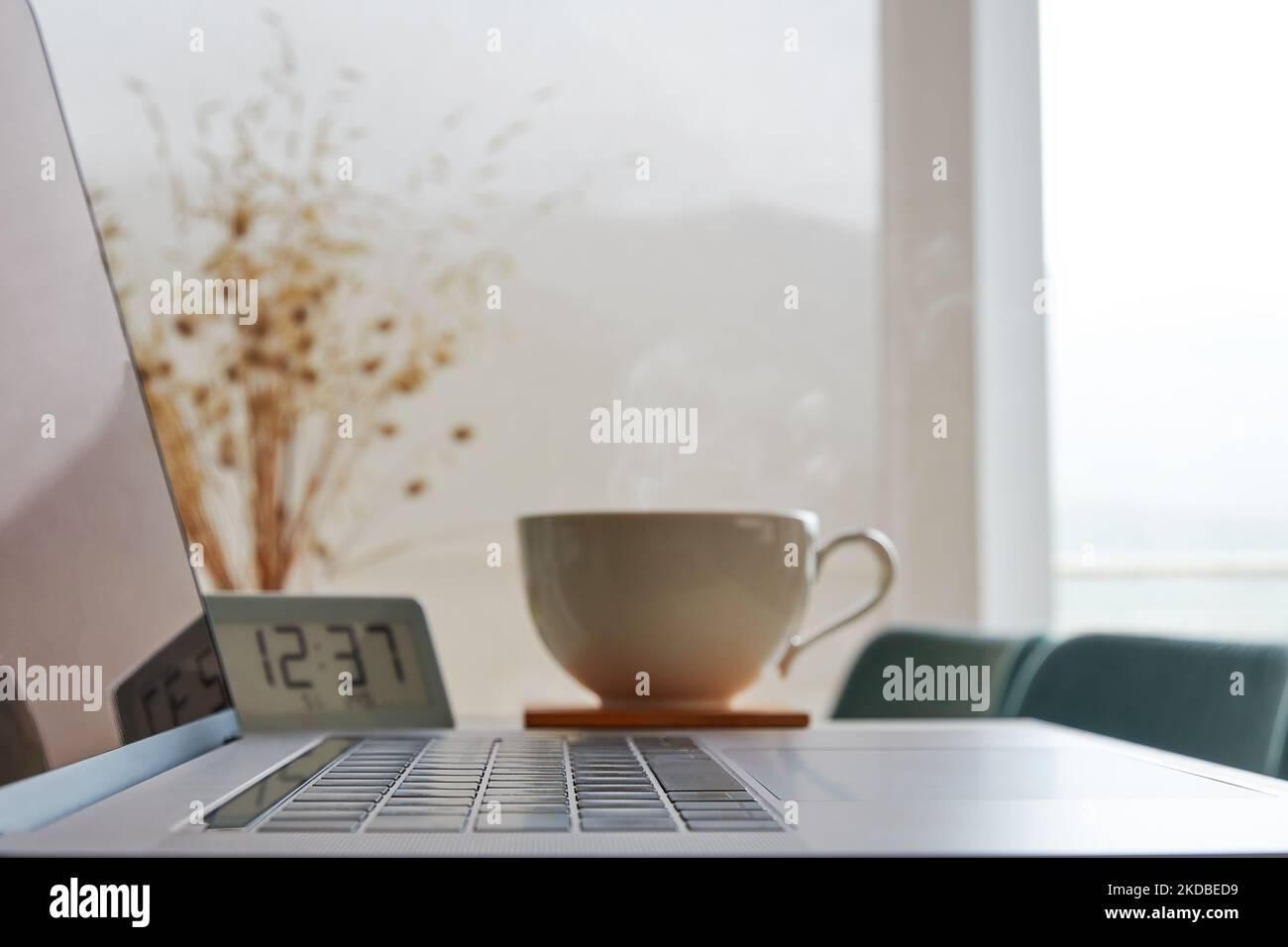 Digital laptop and coffee cup on the home desk. Time for coffee break ...