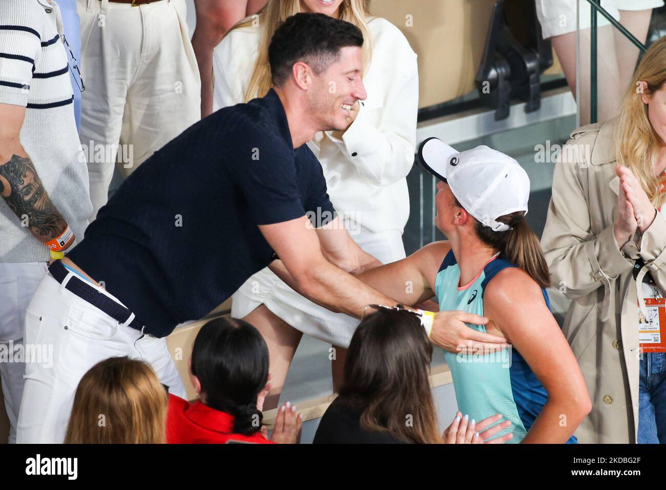 The football player Robert Lewandowski greeting Iga Swiatek after her ...