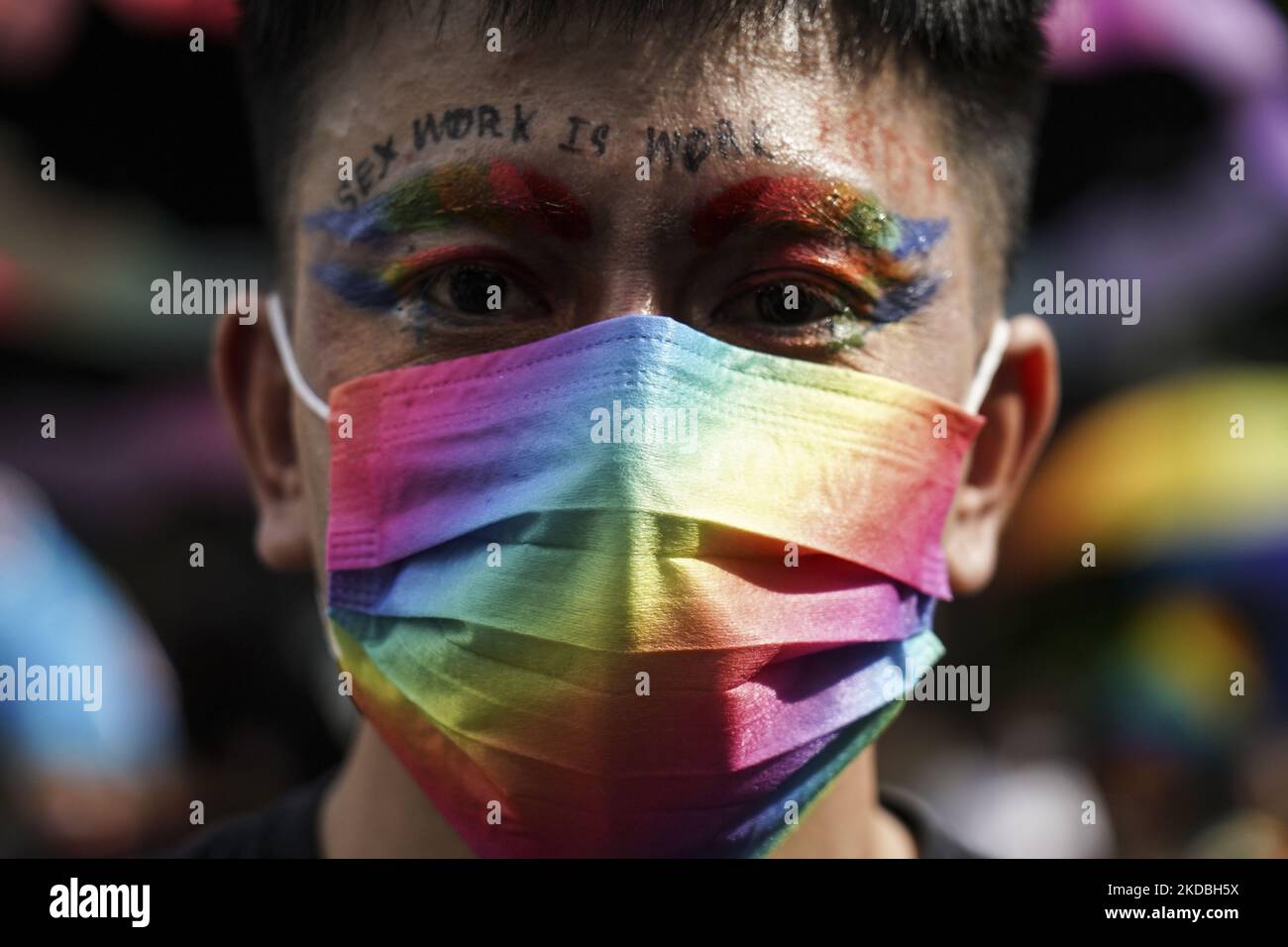 A Thai member of LGBT community wears a rainbow mask during parade to mark pride day 2022 in ...