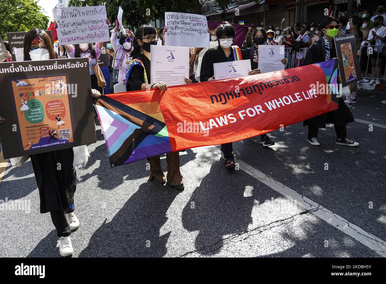 Thai members of LGBT community hold a banner take part in parade to mark pride day 2022 in ...