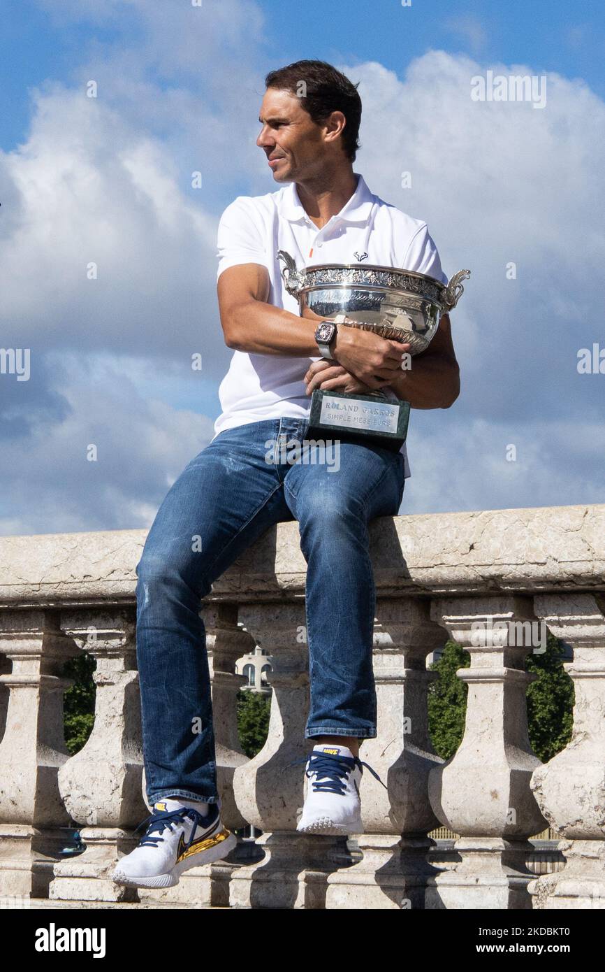 Rafael Nadal of Spain poses with his trophy on the Alexandre III bridge ...