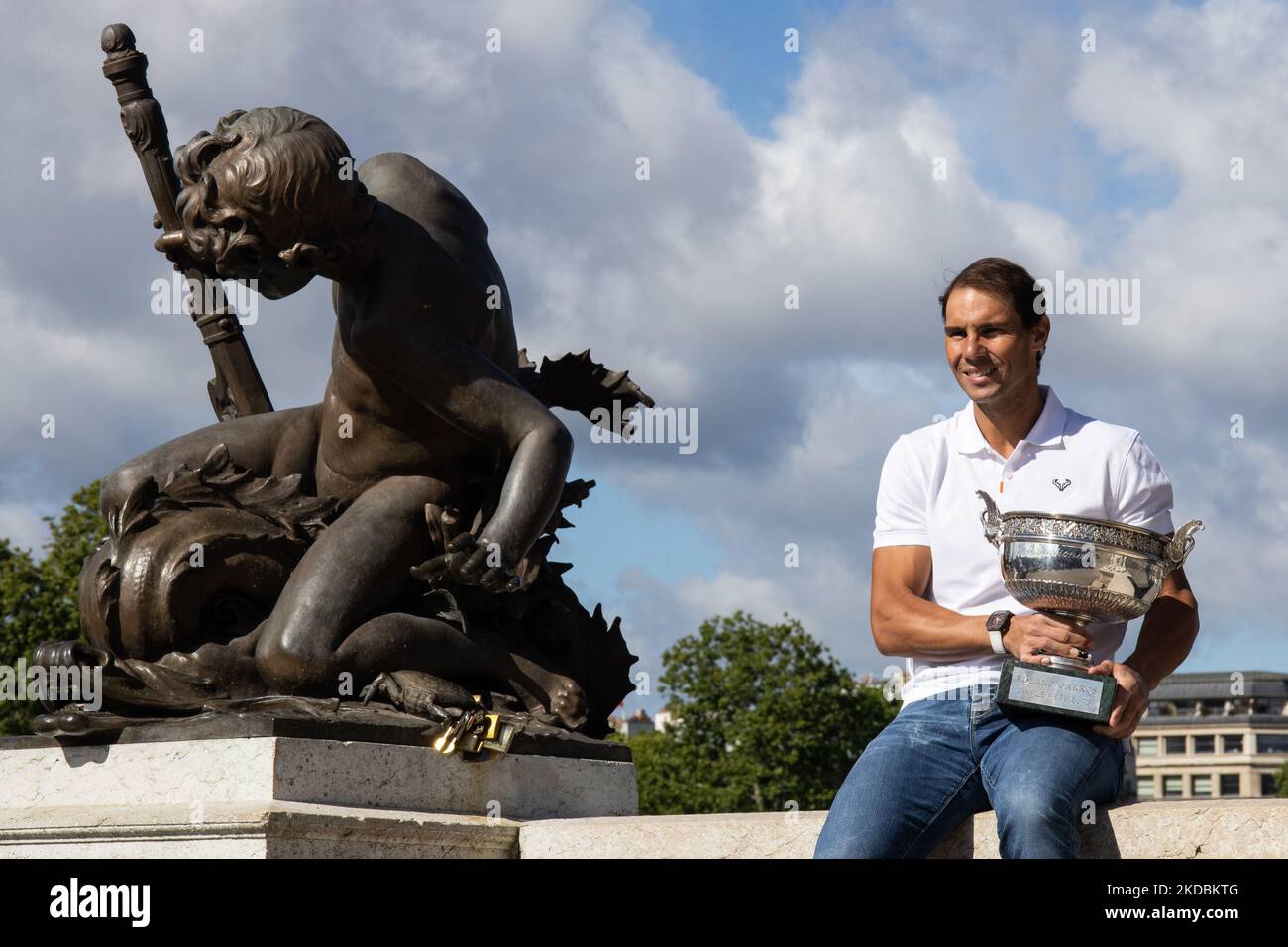 Rafael Nadal of Spain poses with his trophy on the Alexandre III bridge ...