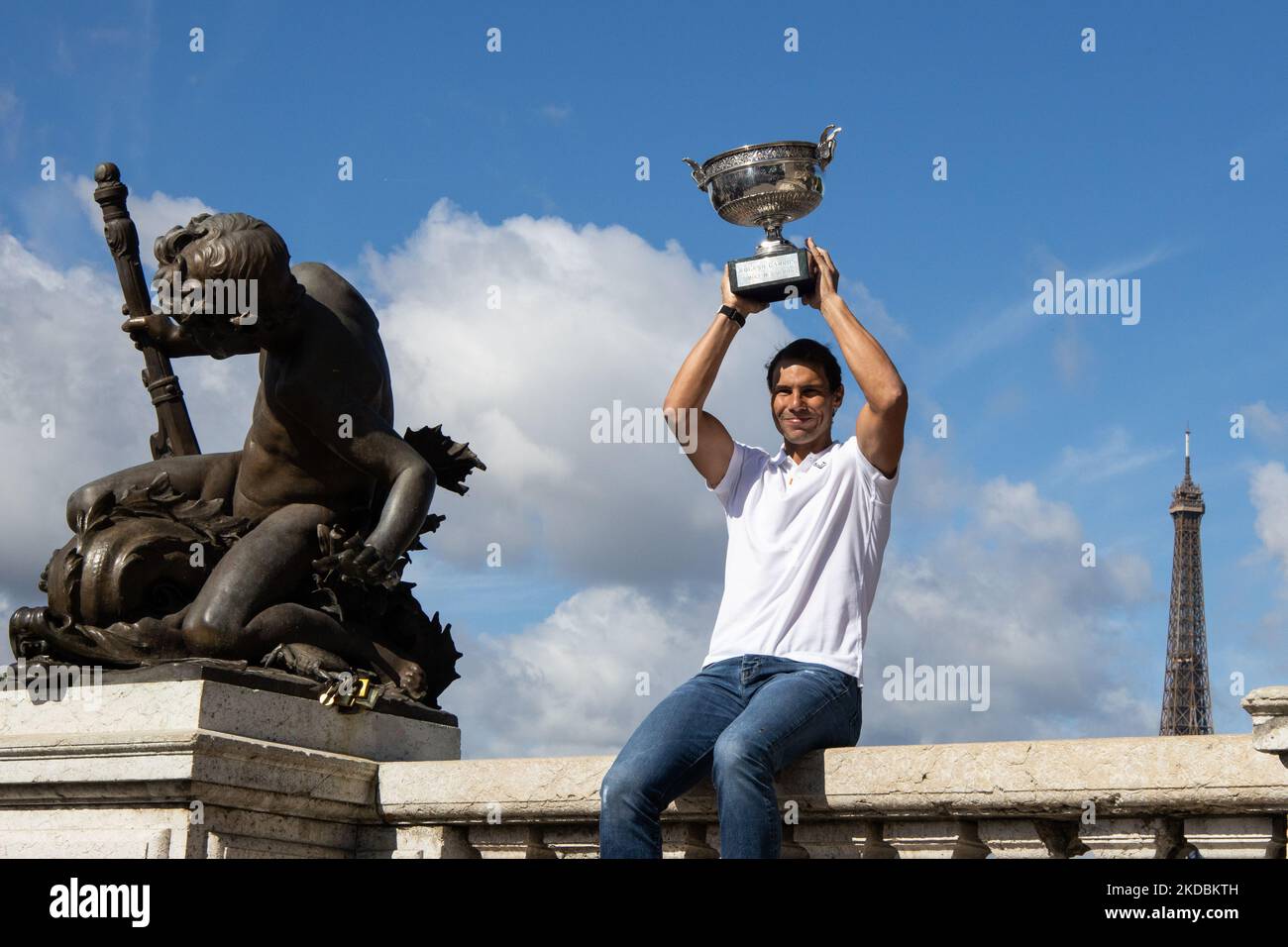 Rafael Nadal of Spain poses with his trophy on the Alexandre III bridge ...