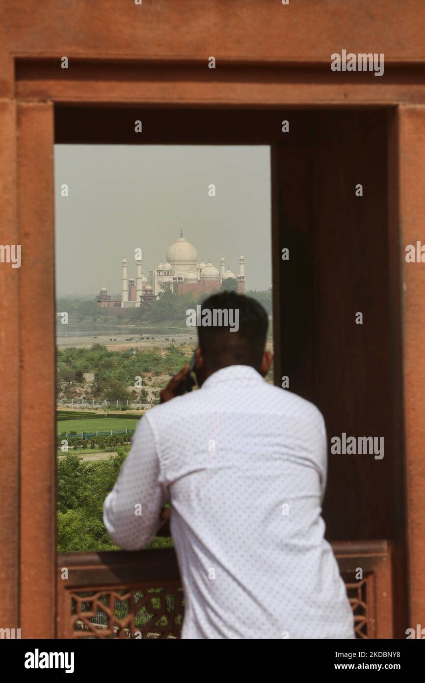 Man looks out at the Taj Mahal seen from Agra Fort in Agra, Uttar ...