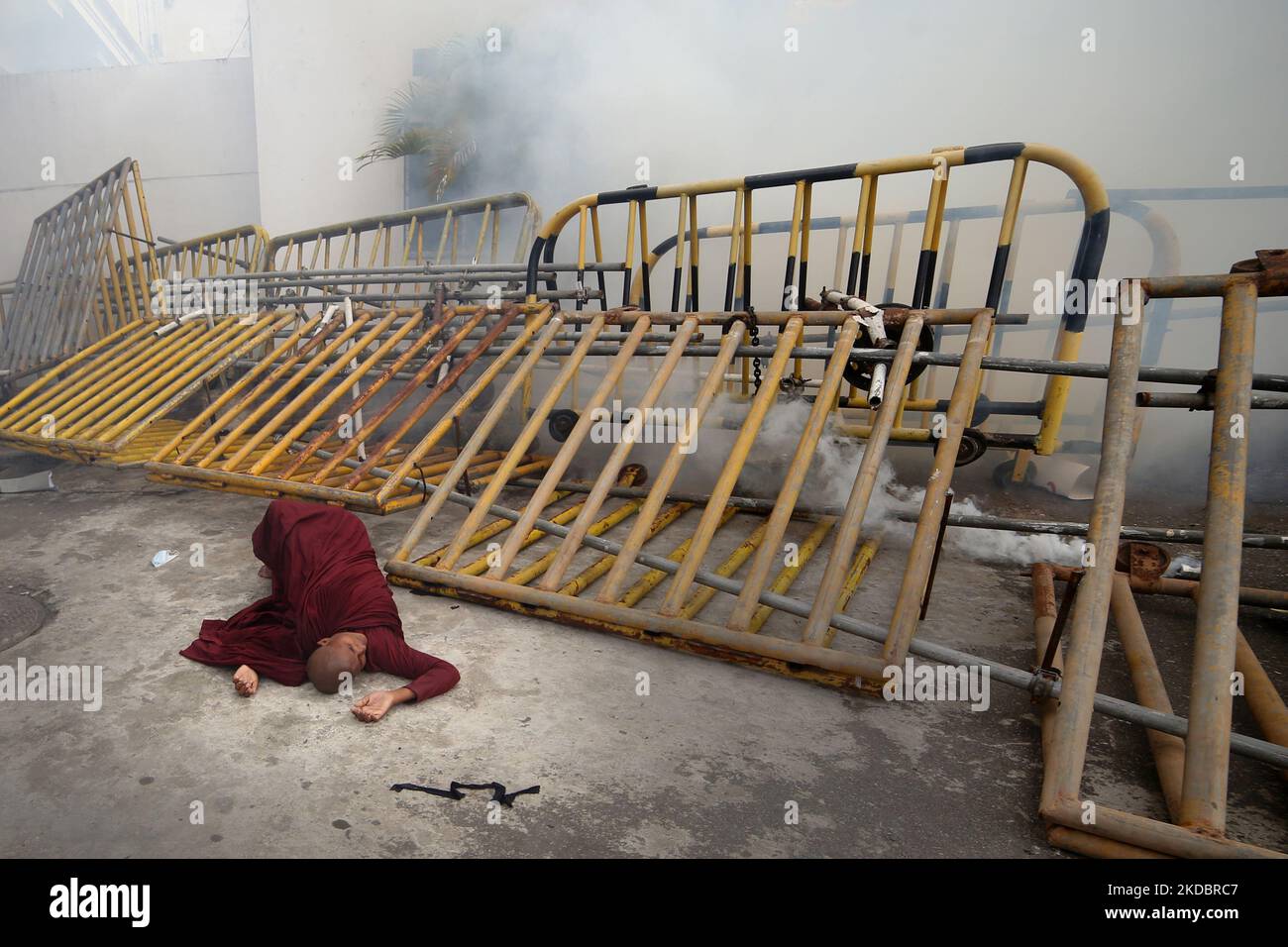 A Sri Lankan Buddhist nun ( Bhikkhuni ) falls on the ground in front of ...