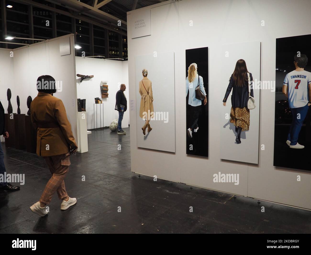 The paintings of walking people at the Discovery Art Fair Stock Photo ...